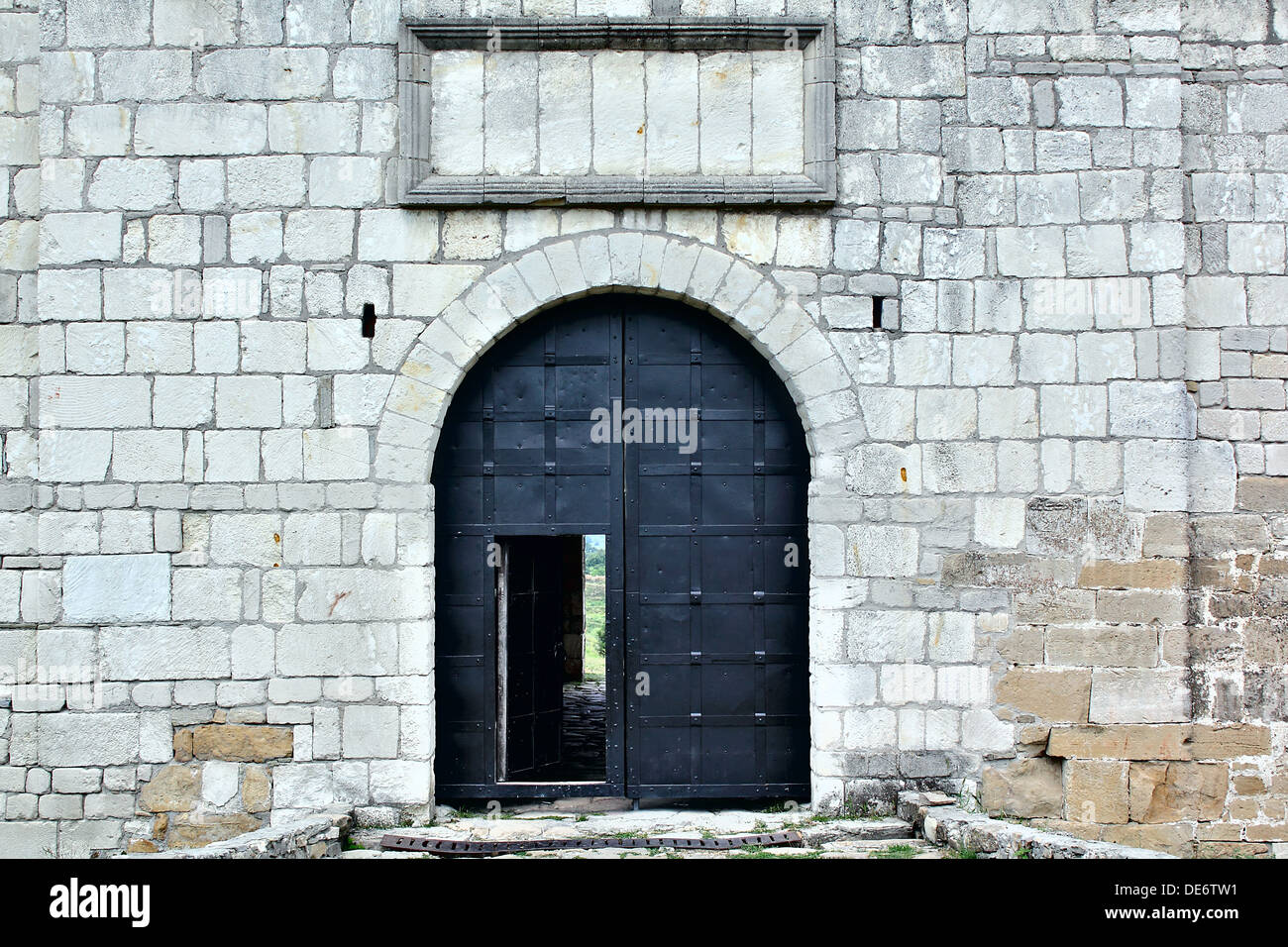 Big iron gates with opened door in the castle Stock Photo - Alamy
