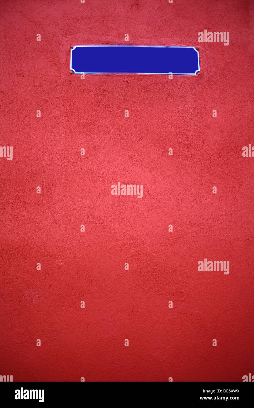 Color shot of an empty blue street sign on a red wall Stock Photo - Alamy