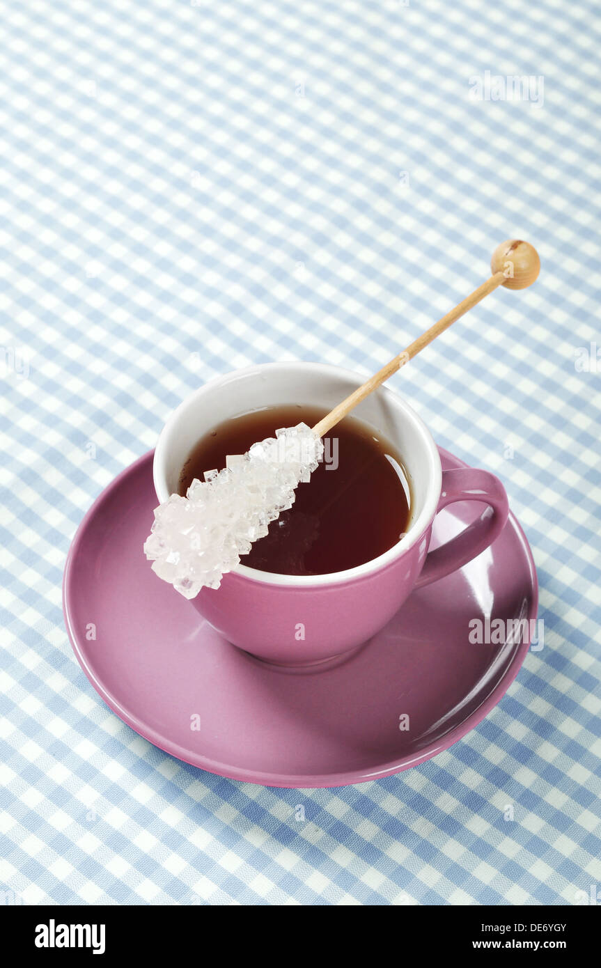 Tea in cup with candy sugar on checkered background Stock Photo - Alamy