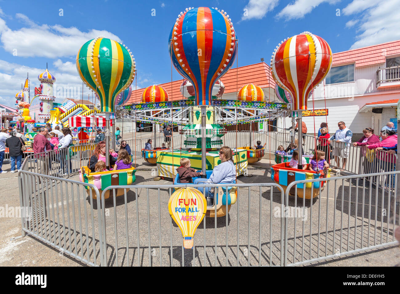 Children and parents enjoy the amusement park rides Stock Photo - Alamy