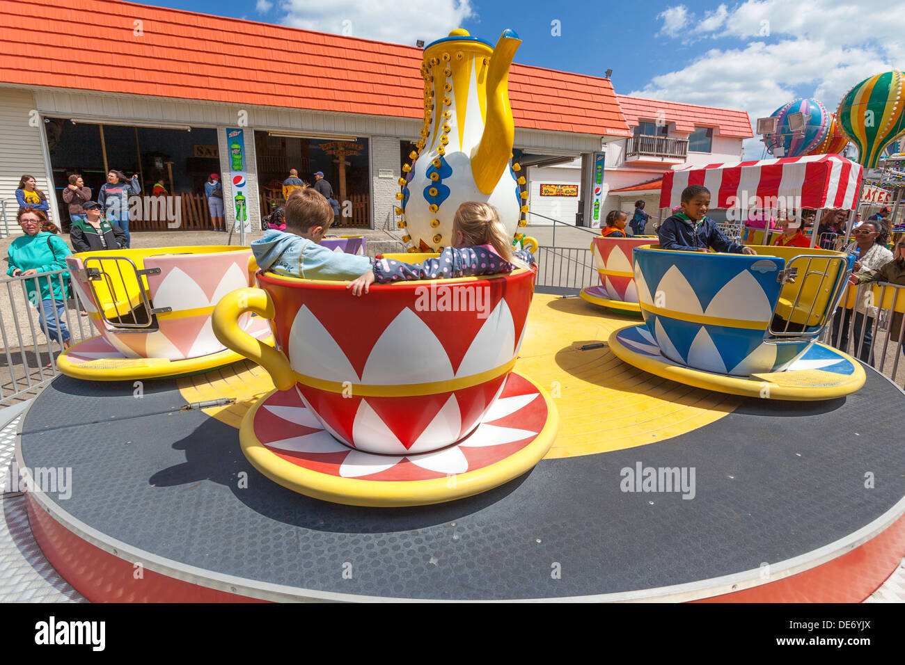 Children and parents enjoy the amusement park rides Stock Photo - Alamy