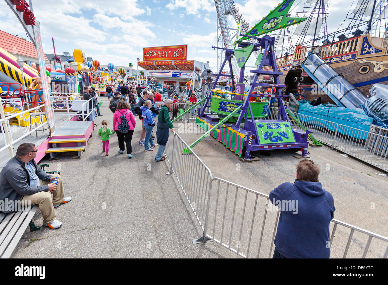 Children and parents enjoy the amusement park rides Stock Photo - Alamy