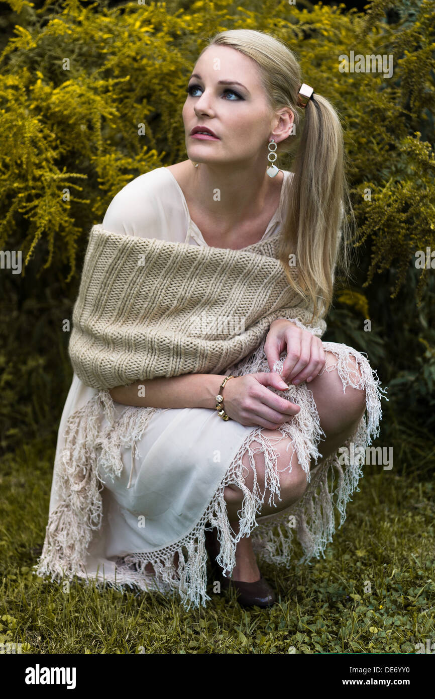 Photo of a sitting woman which looking serious into the nature Stock ...