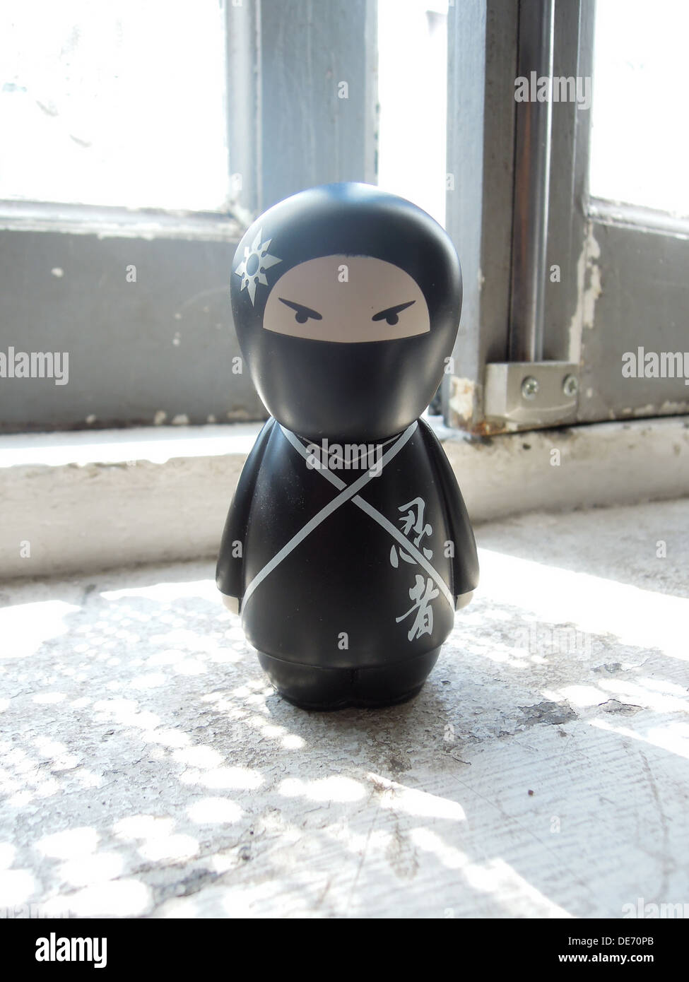 a ninja standing next to the window Stock Photo - Alamy