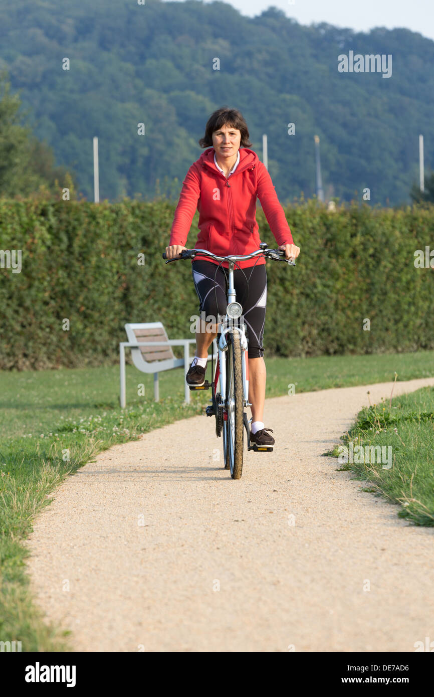 Healthy active Woman on a bike ride Outdoors Stock Photo - Alamy