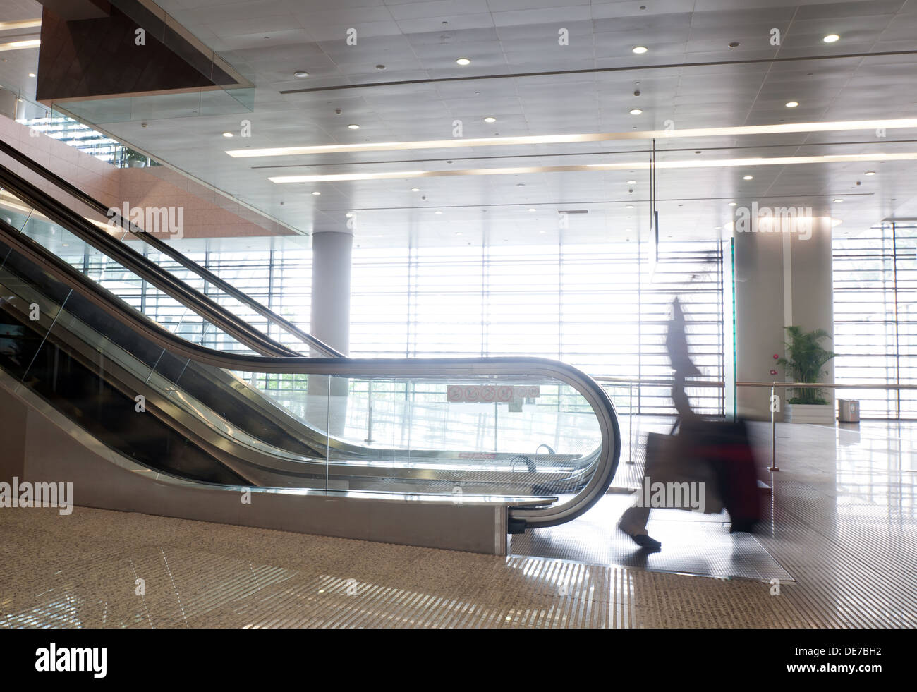passenger rushing through an escalator in airport terminal Stock Photo ...