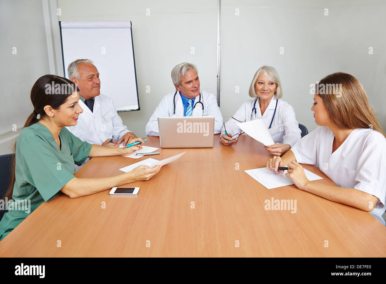 Group of doctors with applicant at job interview for a hospital Stock ...