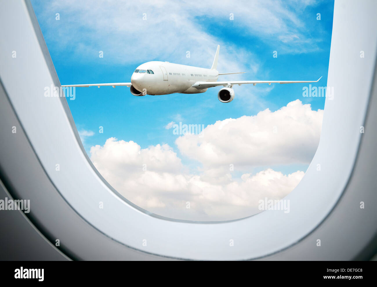 Through the aircraft windows, Large passenger plane flying in the blue ...