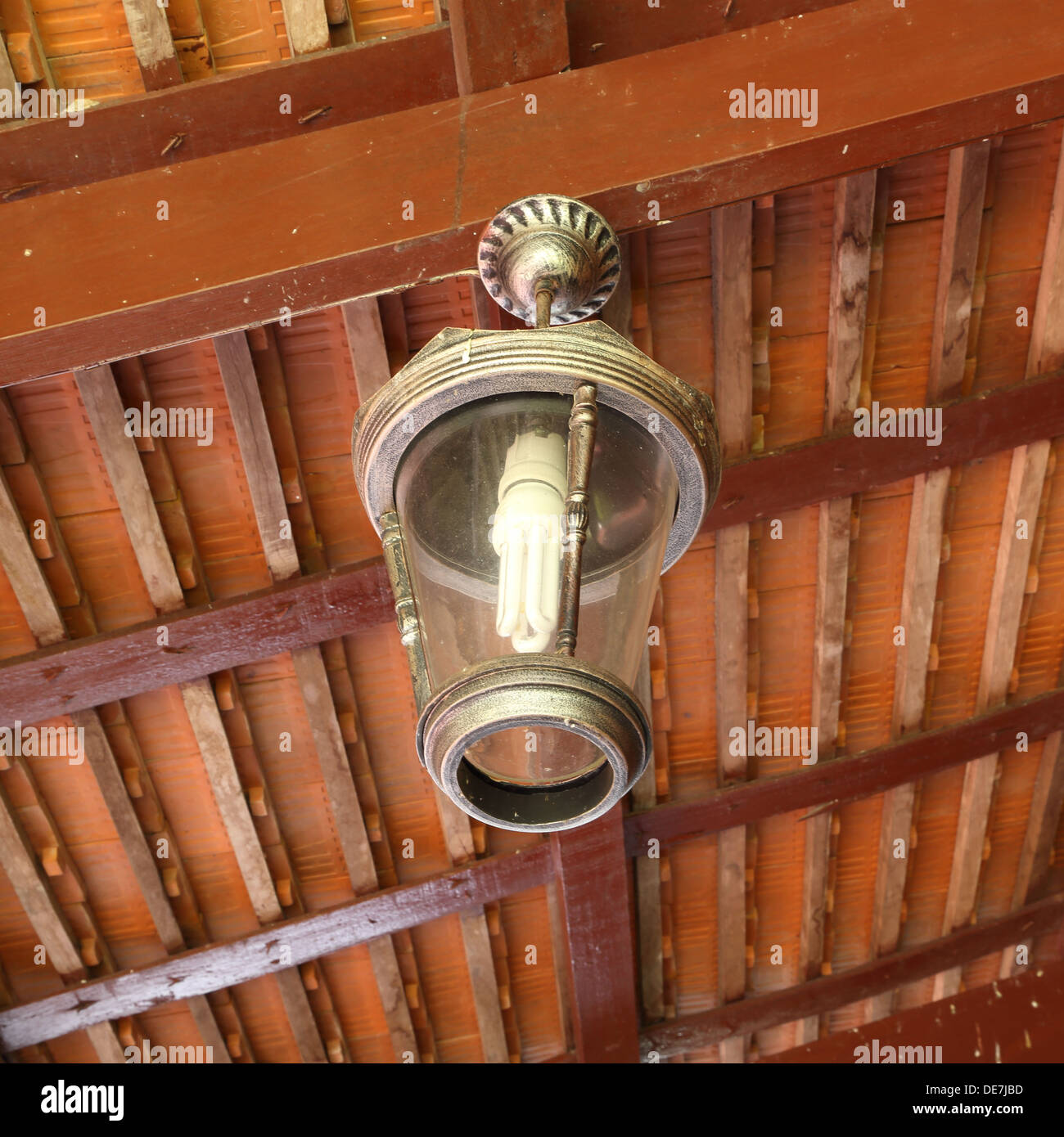 old lamp hanging from the ceiling under a wooden canopy Stock Photo - Alamy