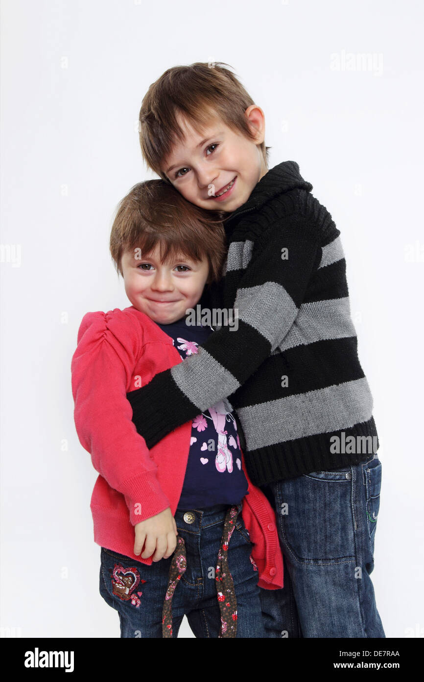 Portrait of brother and sister embracing each other, smiling Stock ...
