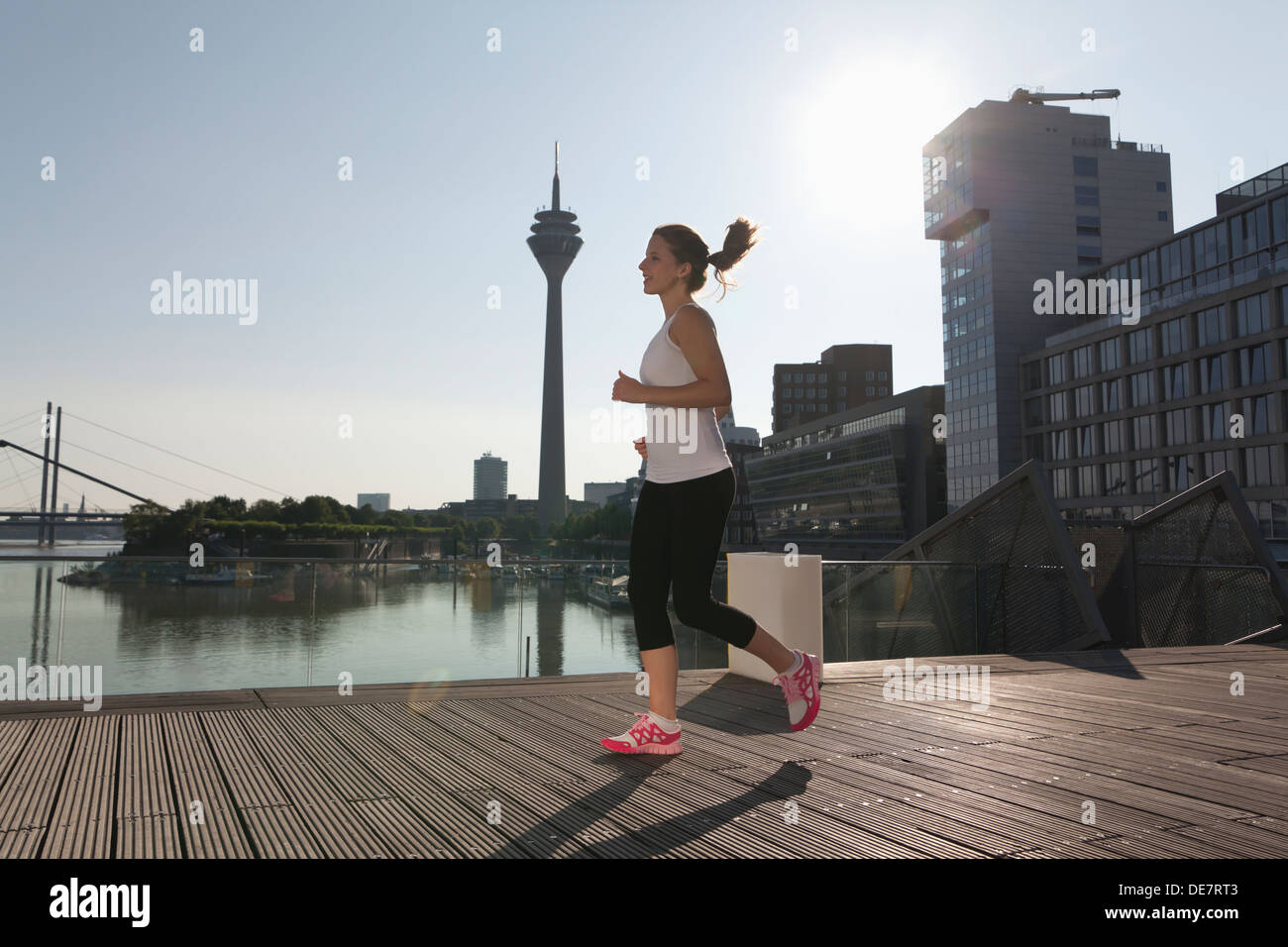 Germany, North Rhine Westphalia, Duesseldorf, Young woman jogging Stock ...