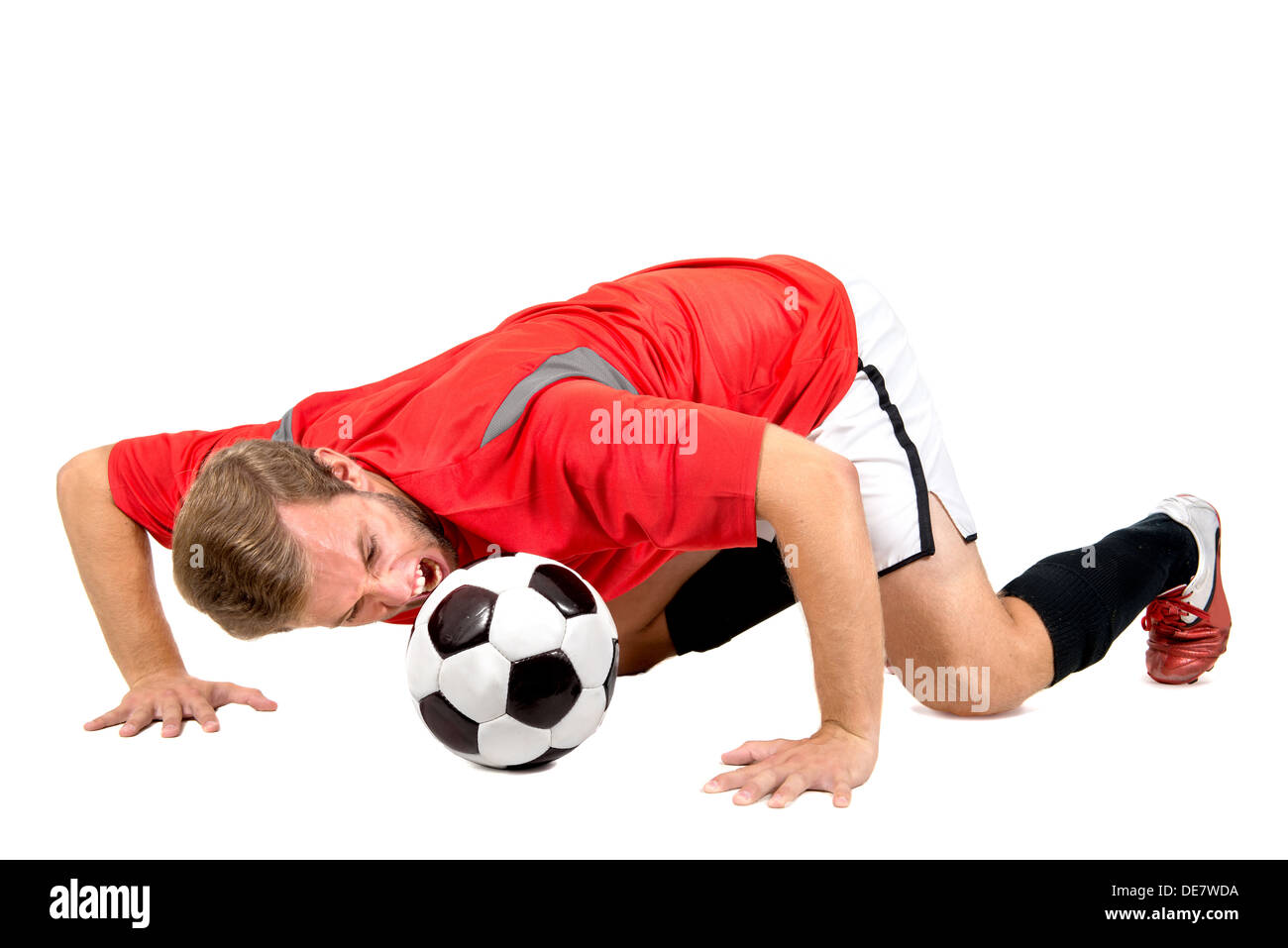 Football player screaming at the ball isolated in white Stock Photo - Alamy