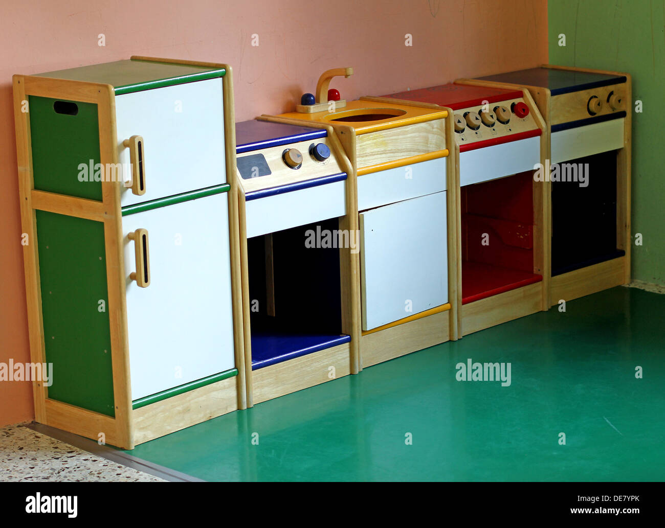 small wooden toy kitchen to play and amuse the children of a nursery ...