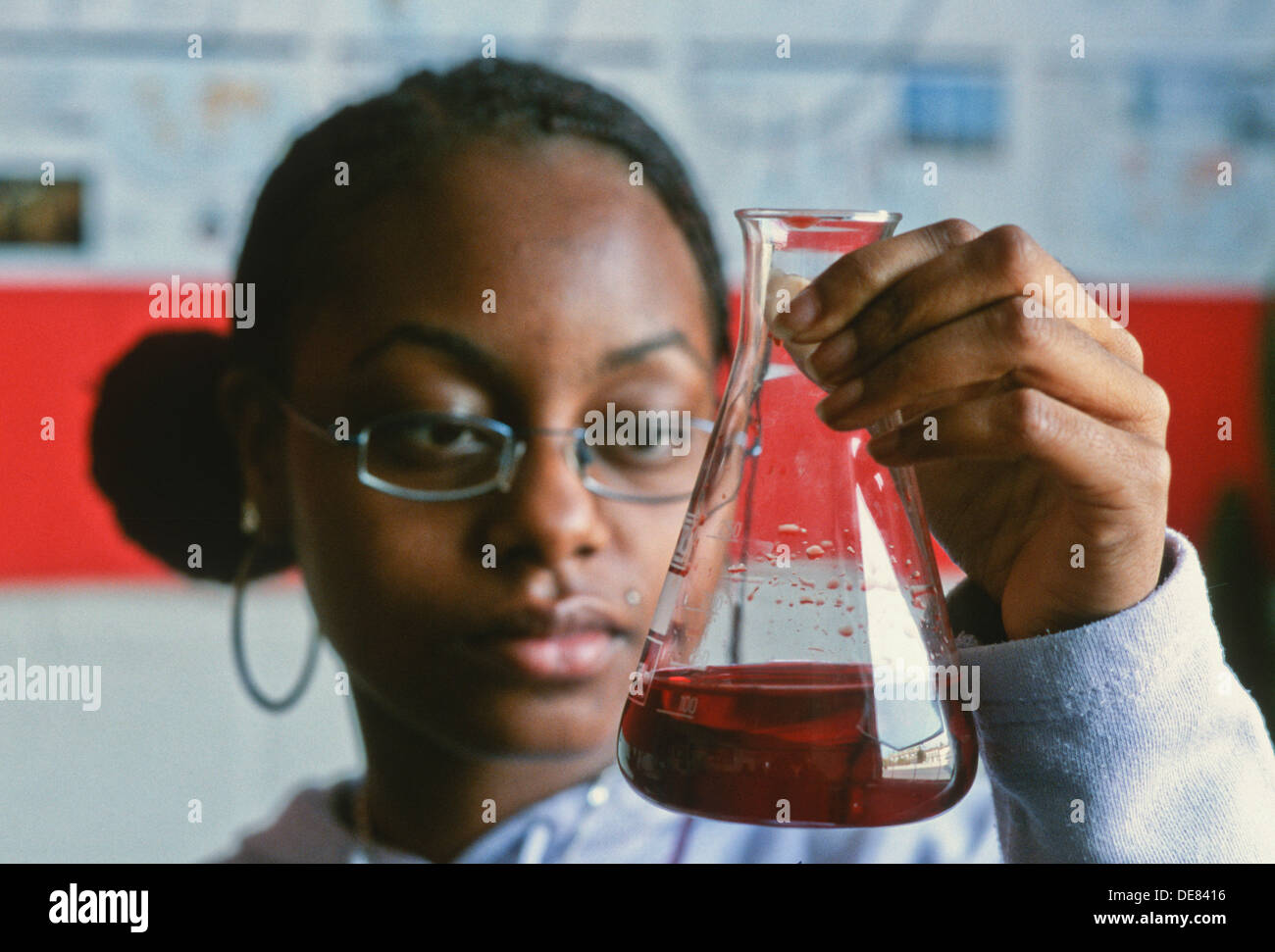 Sixth Form black woman student at chemistry laboratory at a college in ...