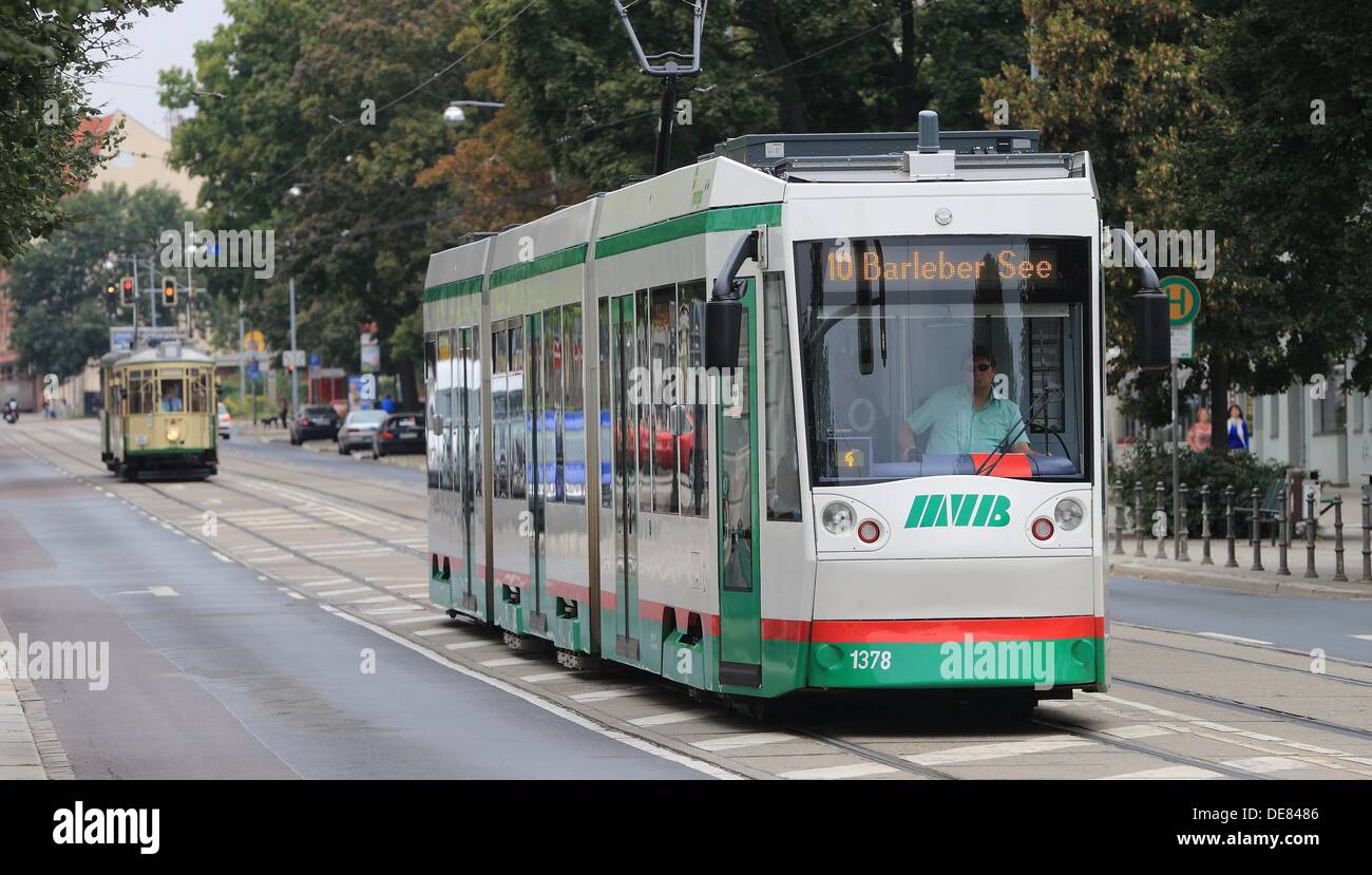 A modern low-floor tram and a historical railcar from 1943 (BACK) drive ...