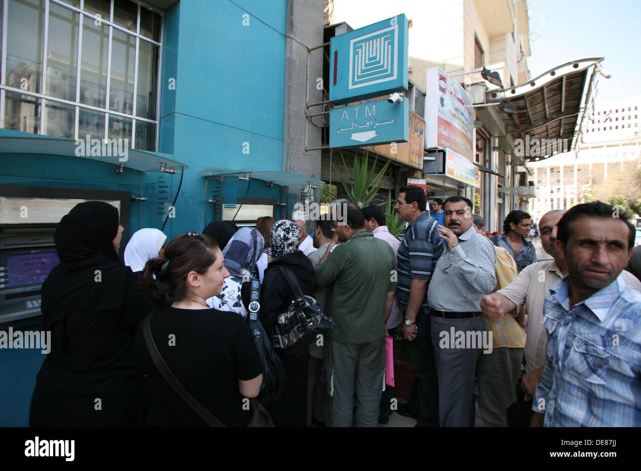 A line of people in front of ATMs in the street of Damascus, 12.09.2013 ...