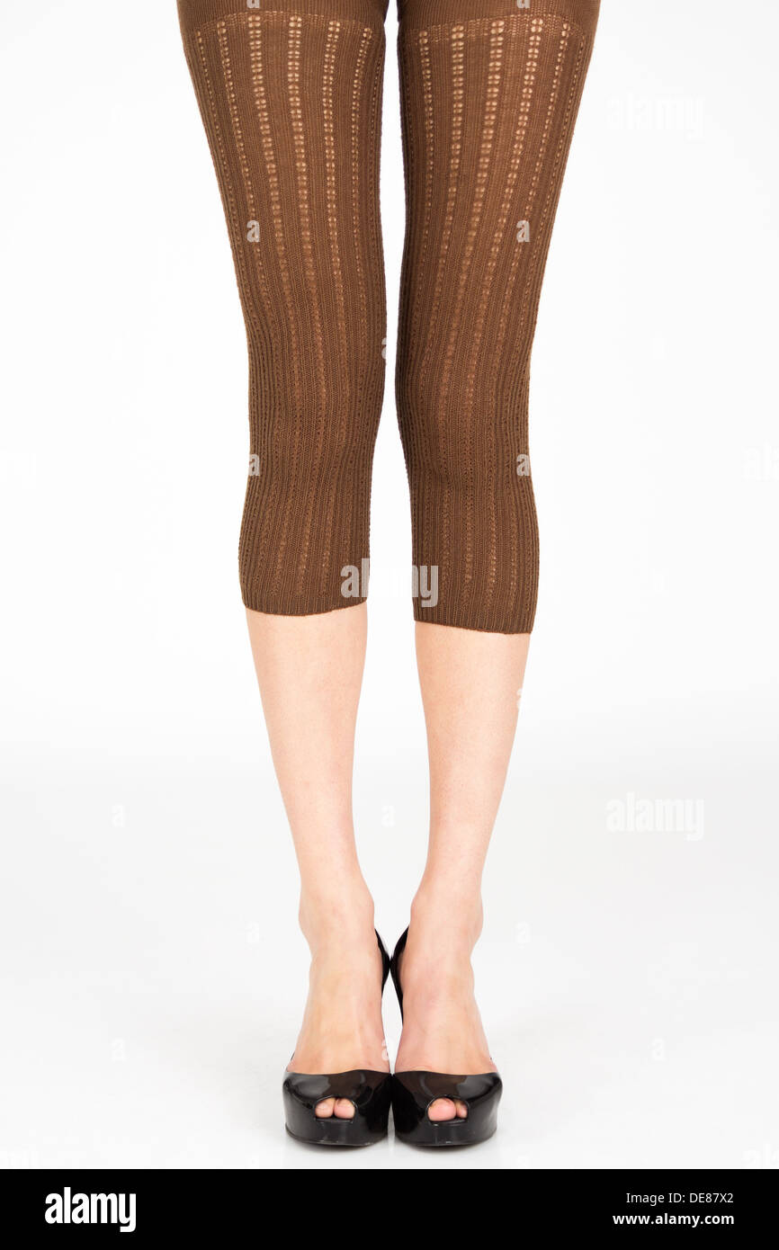 Long Slim legs wearing colorful leggins on plain background Stock Photo ...