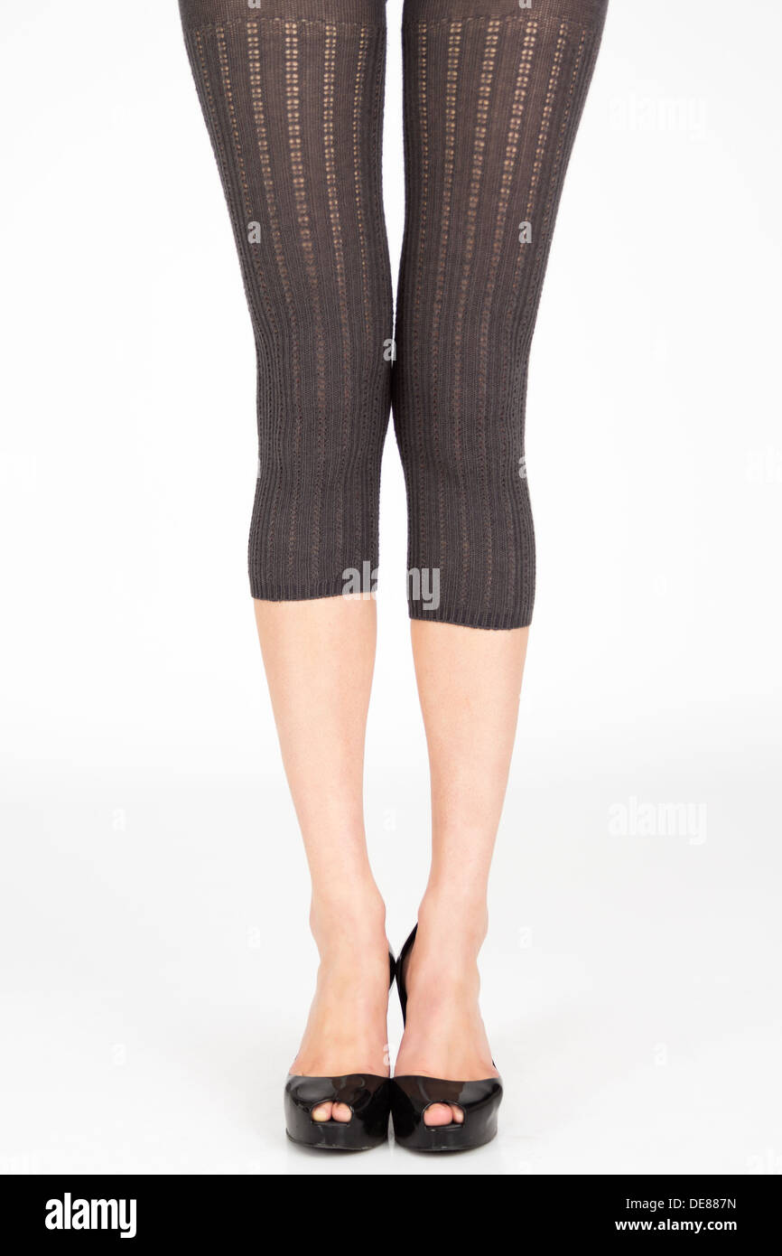 Long Slim legs wearing colorful leggins on plain background Stock Photo ...