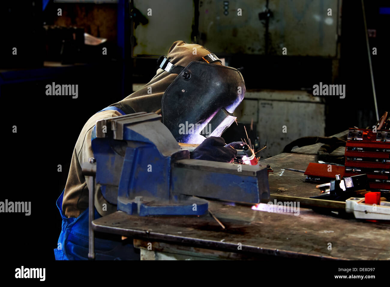 Welder working in production workshop on a workbench Stock Photo - Alamy