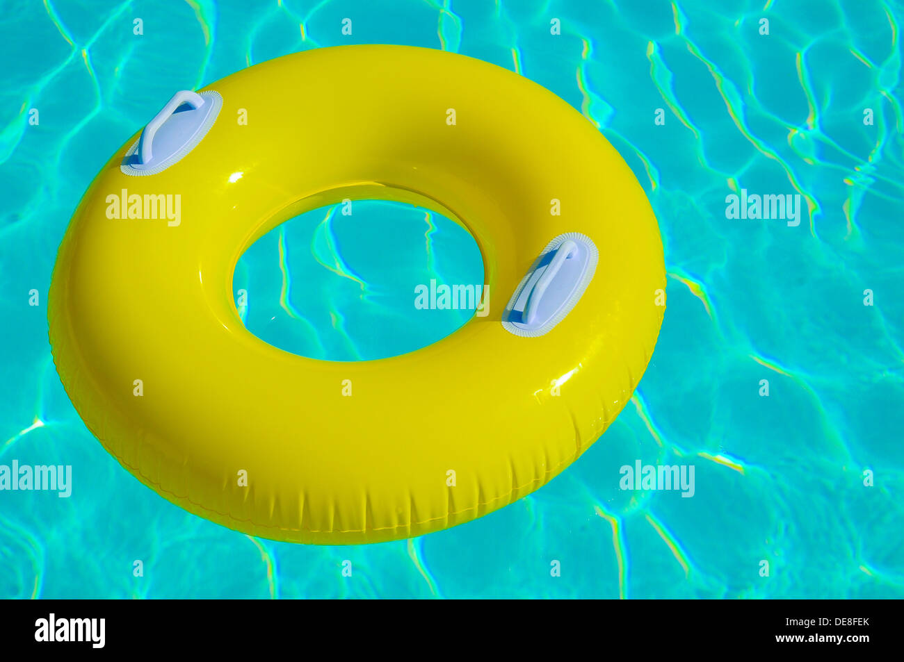 An inflatable ring floating in a swimming pool Stock Photo - Alamy