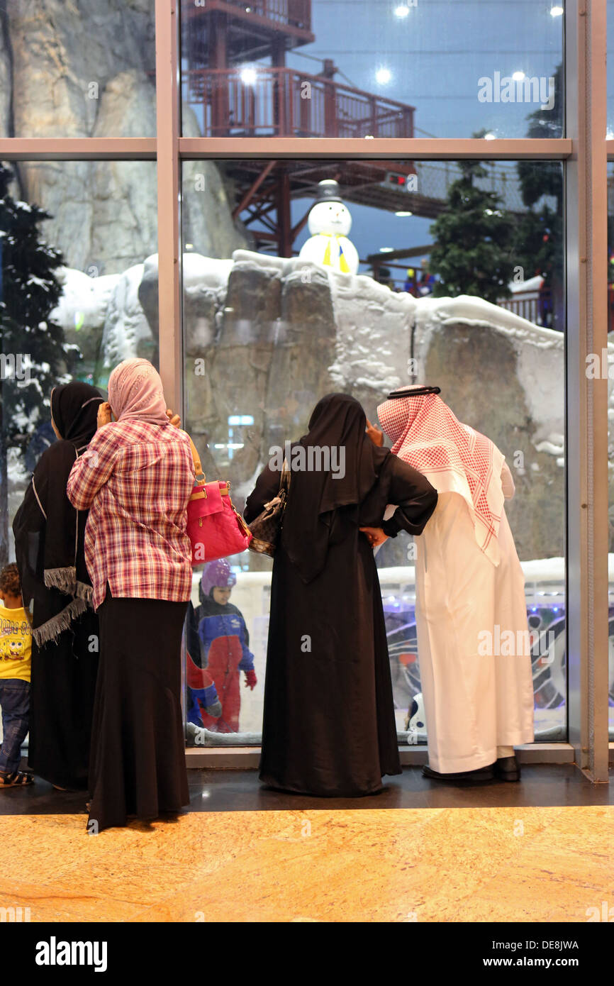 Dubai, United Arab Emirates, locals look through a window of the indoor ...