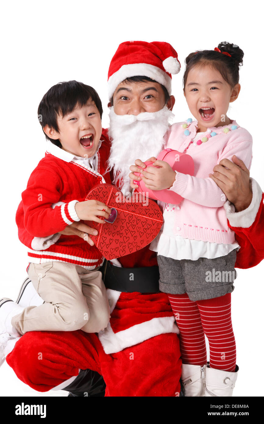 Boy with young man in Santa costume Stock Photo - Alamy