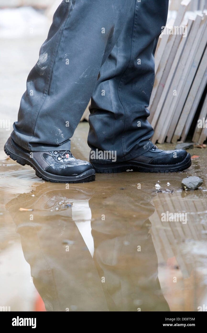 Worker with safety boots. Building construction Stock Photo - Alamy