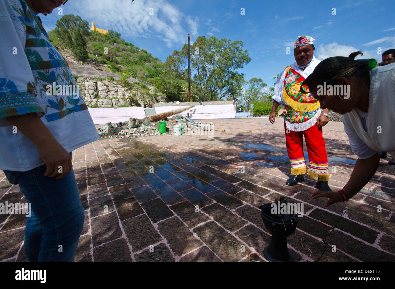 Ritual preparation burning incense by a Volador before the tree trunk ...