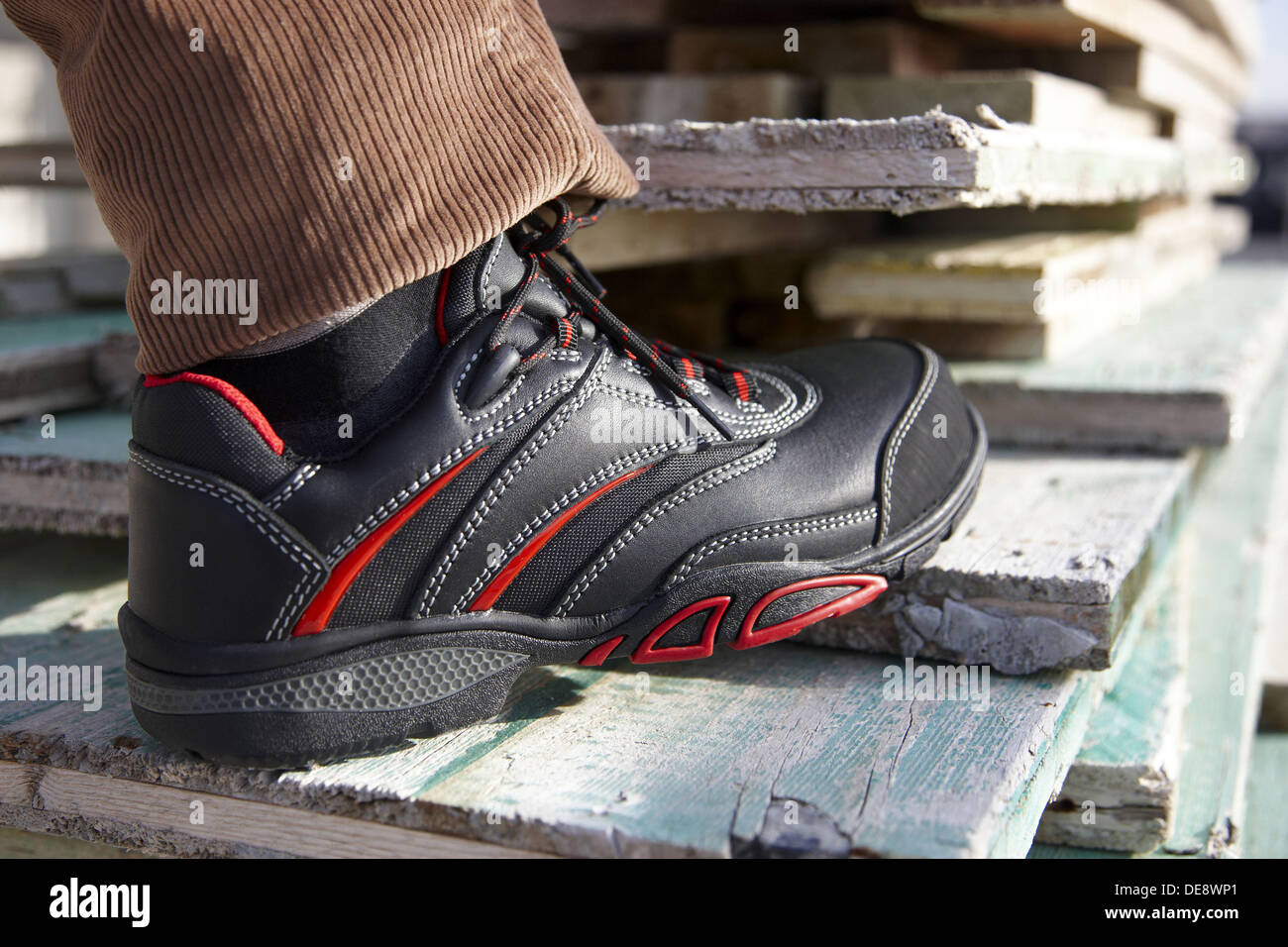 Safety boots, housing construction, plank moulds Stock Photo - Alamy