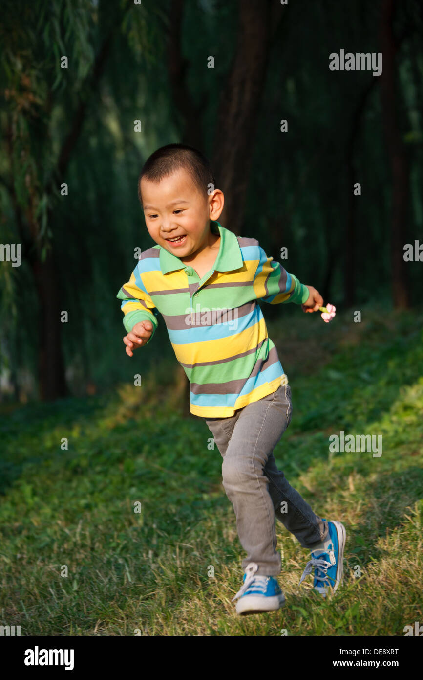 Beautiful cheerful boy walking playing hi-res stock photography and ...