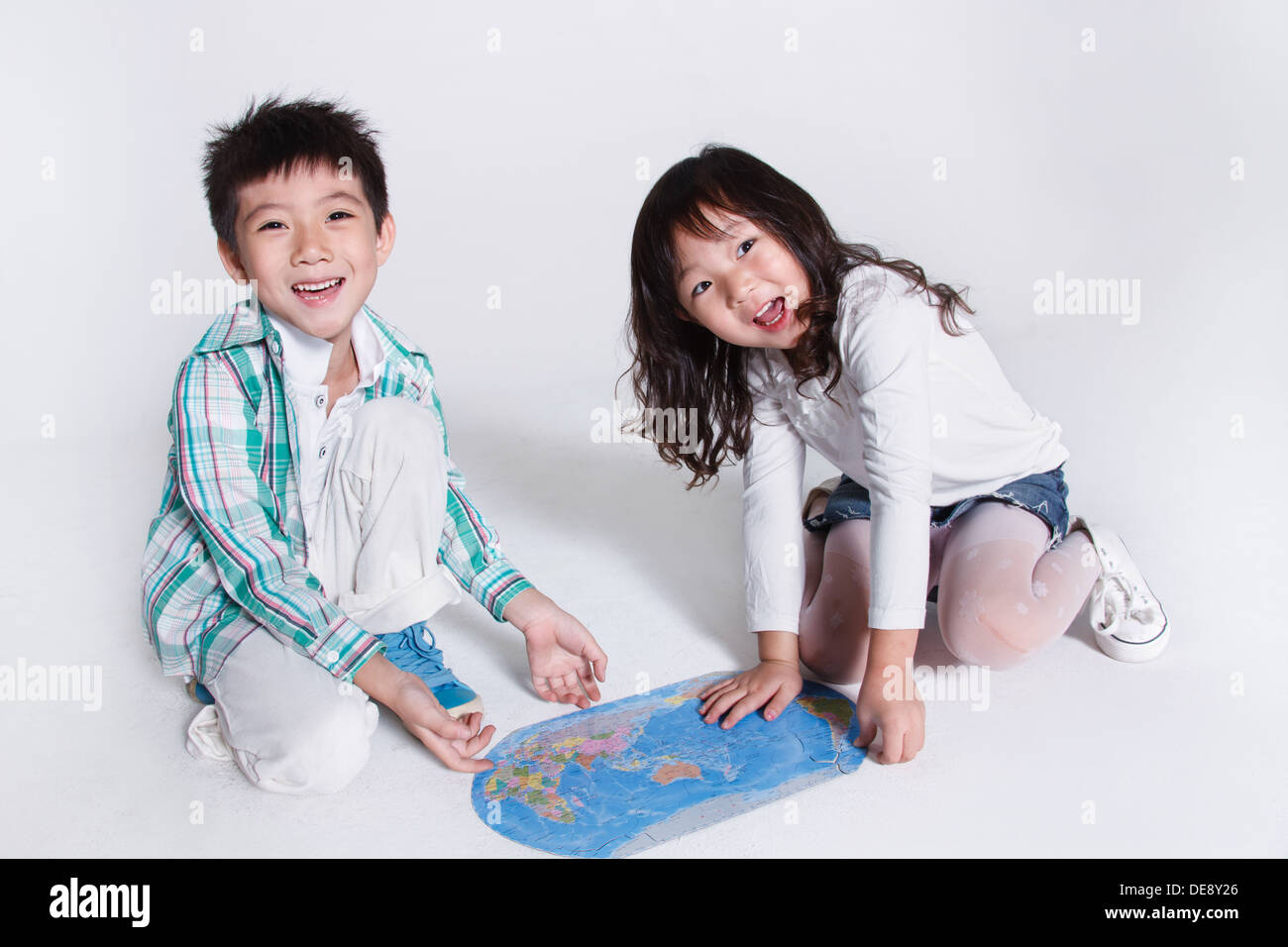 Boy and girl with global map Stock Photo - Alamy