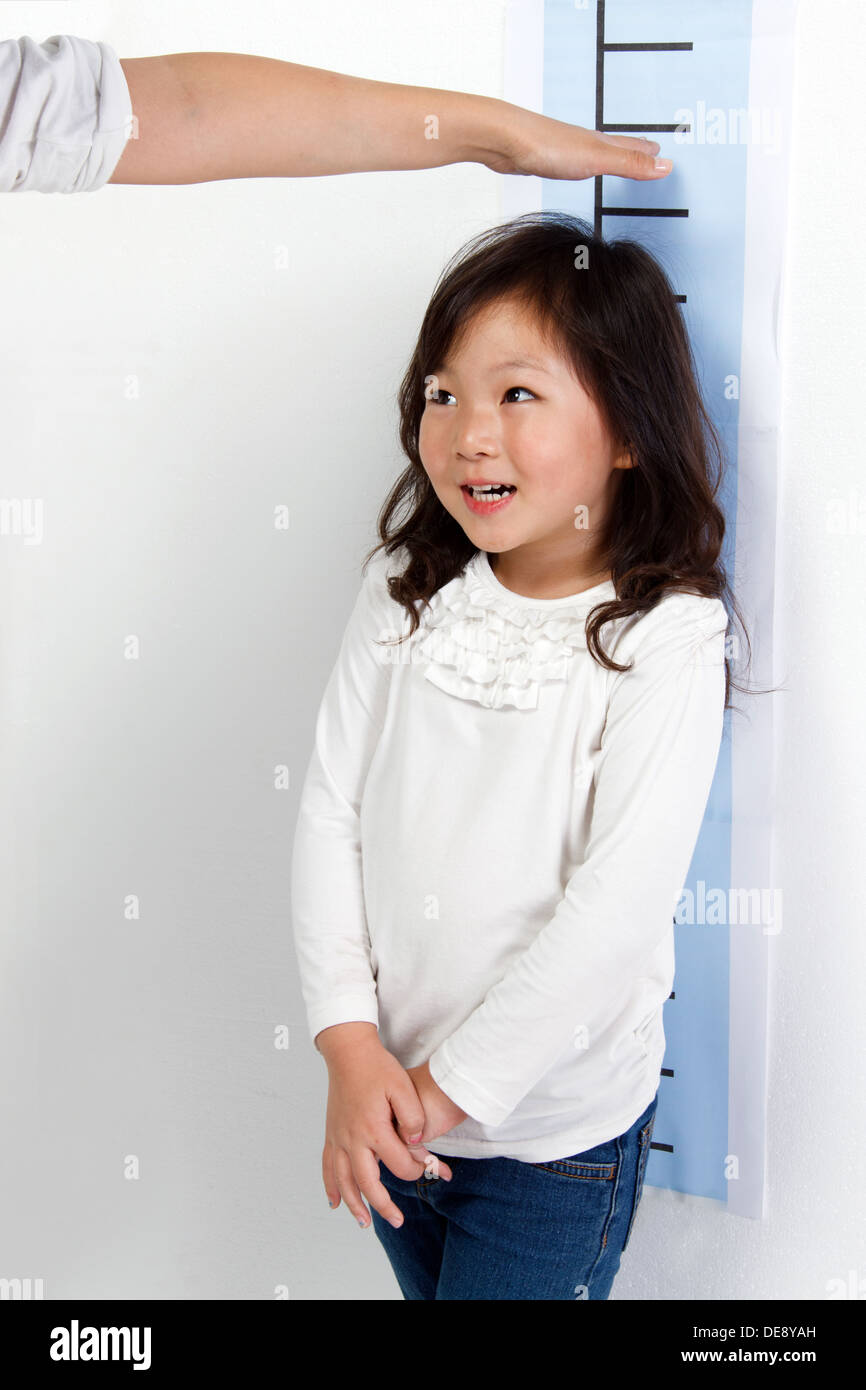 Girl measuring height Stock Photo - Alamy