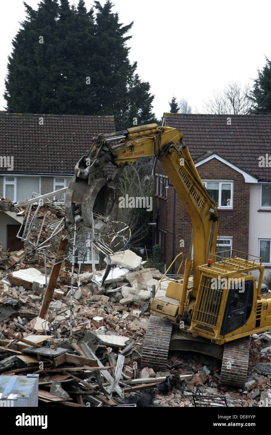 The Demolition of a Small block of Flats using an excavator. Removing ...