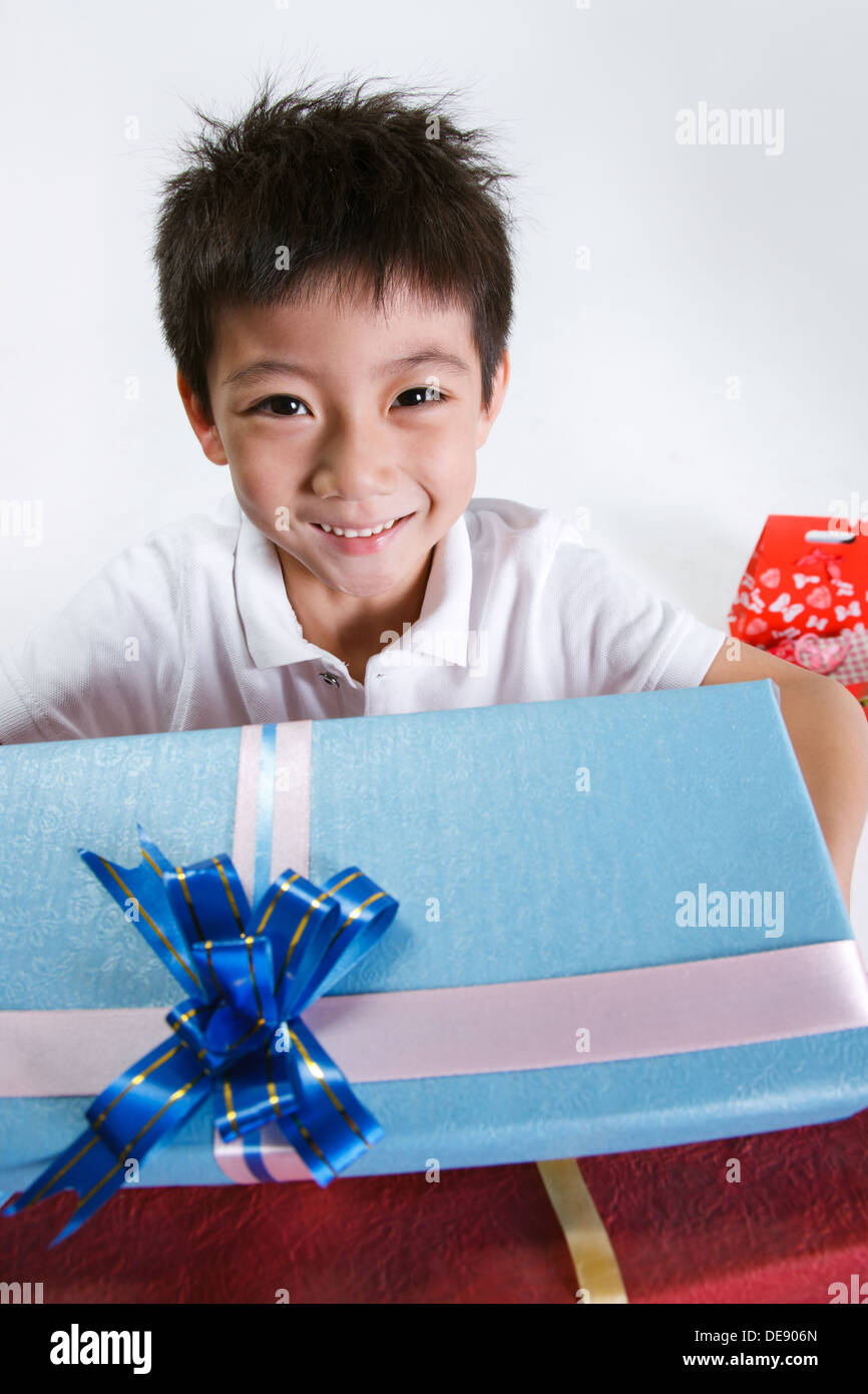 Boy holding gift boxes Stock Photo - Alamy