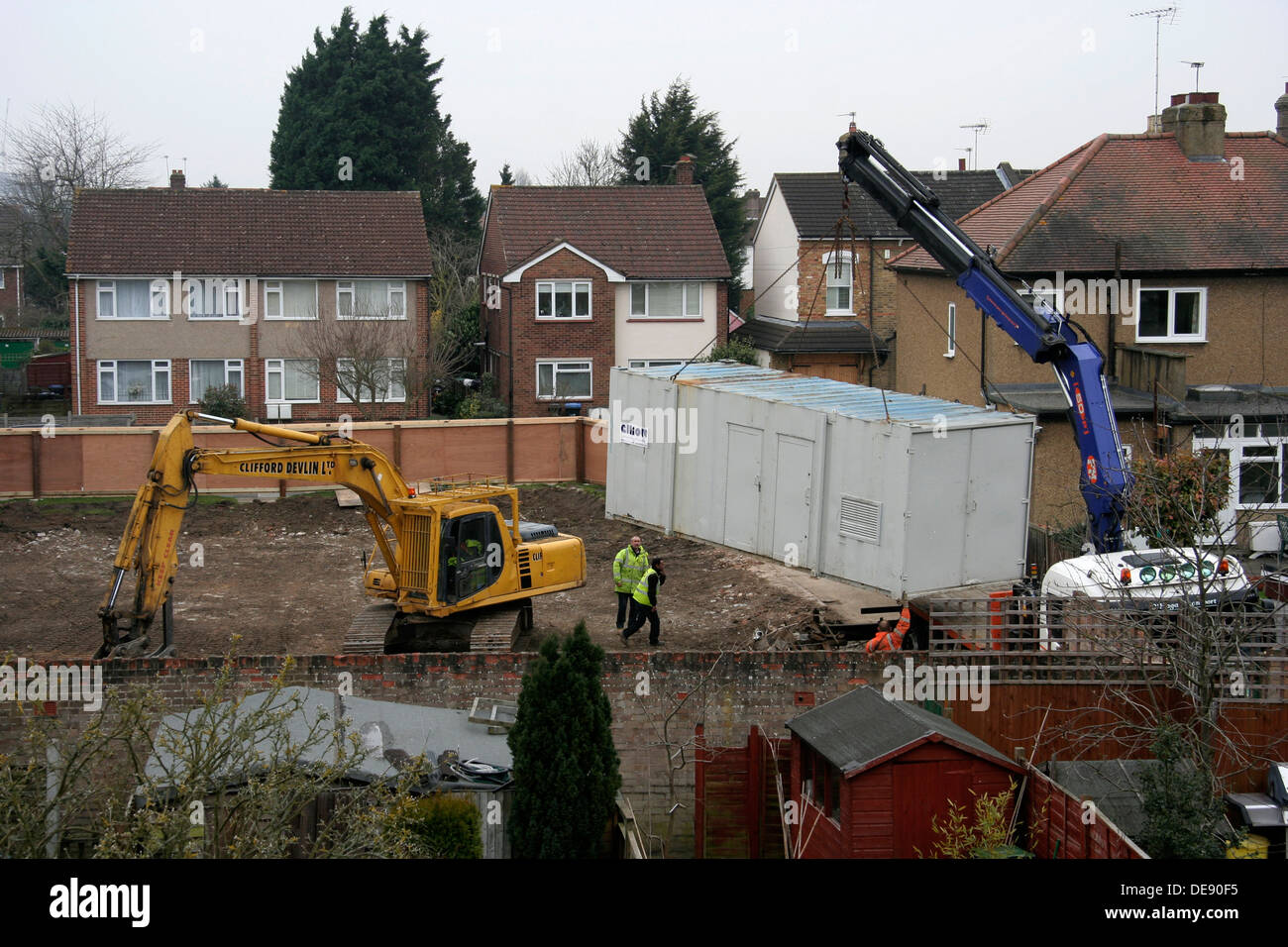 The Demolition of a Small block of Flats using an excavator. Clearing ...