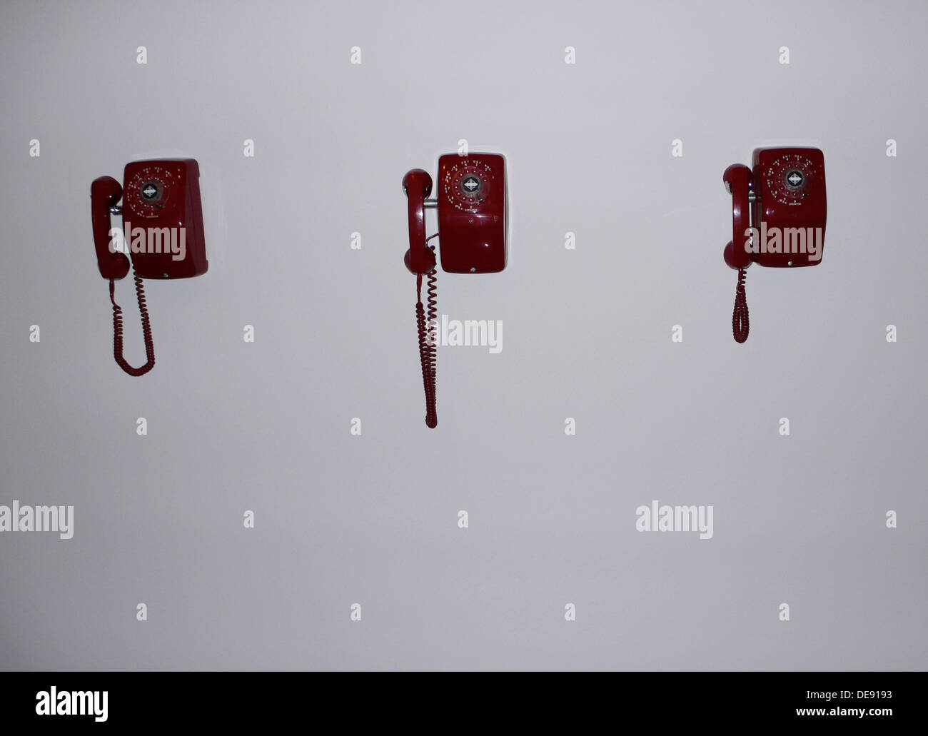 Three Red Telephones on Wall Stock Photo - Alamy