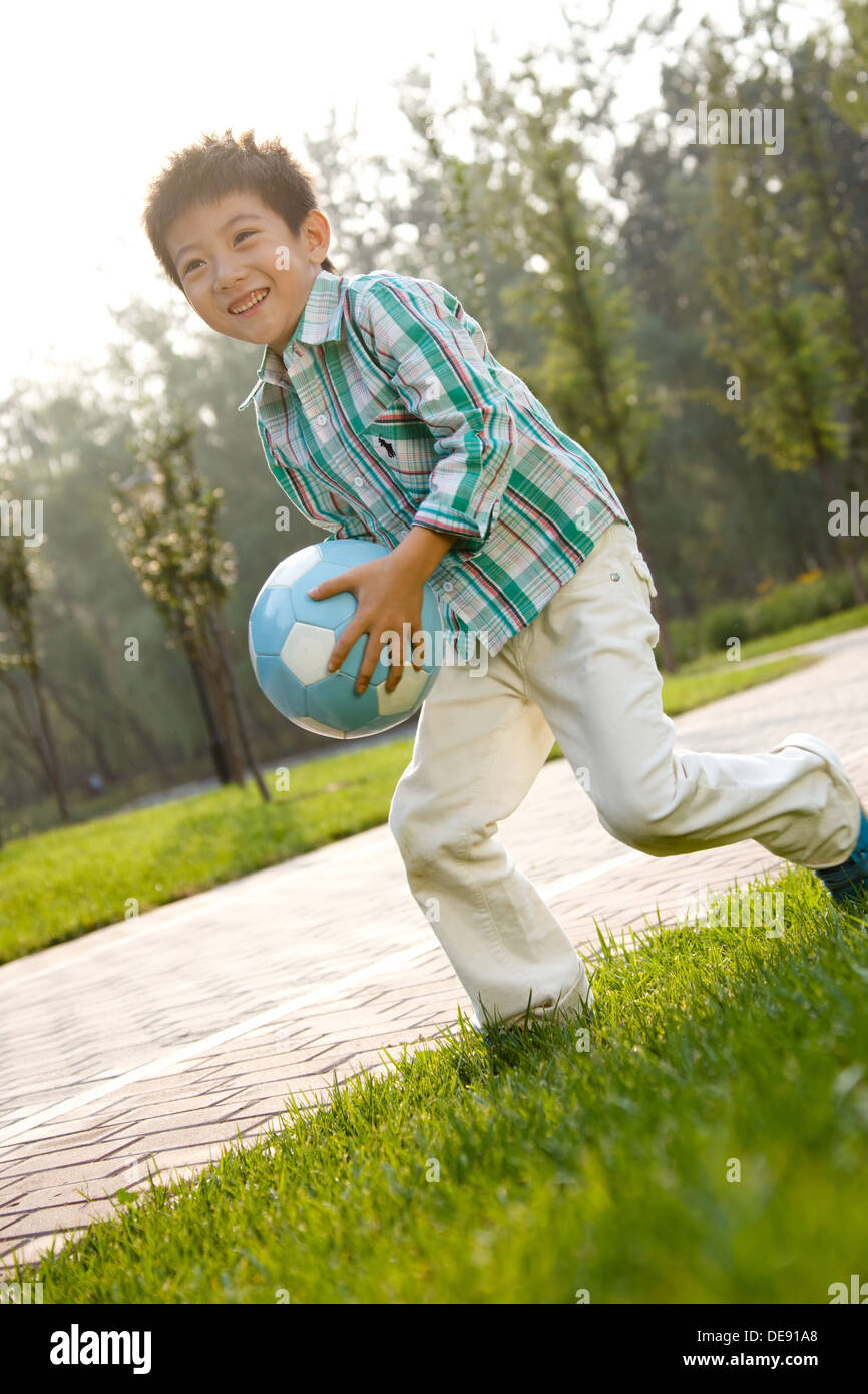 Boy playing soccer Stock Photo - Alamy