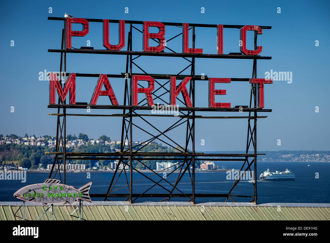Neon sign at Pike Place Market in downtown Seattle with a ferry boat on ...