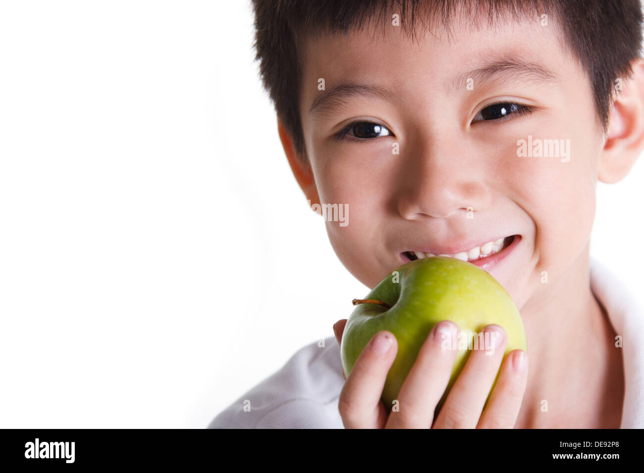 Boy eating apple Stock Photo - Alamy