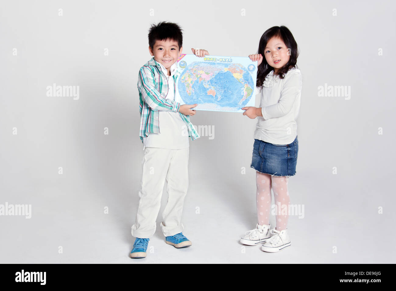 Boy and girl with map Stock Photo - Alamy