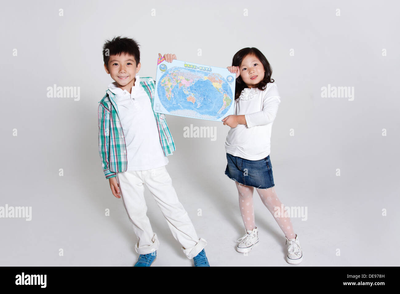 Boy and girl with map Stock Photo - Alamy