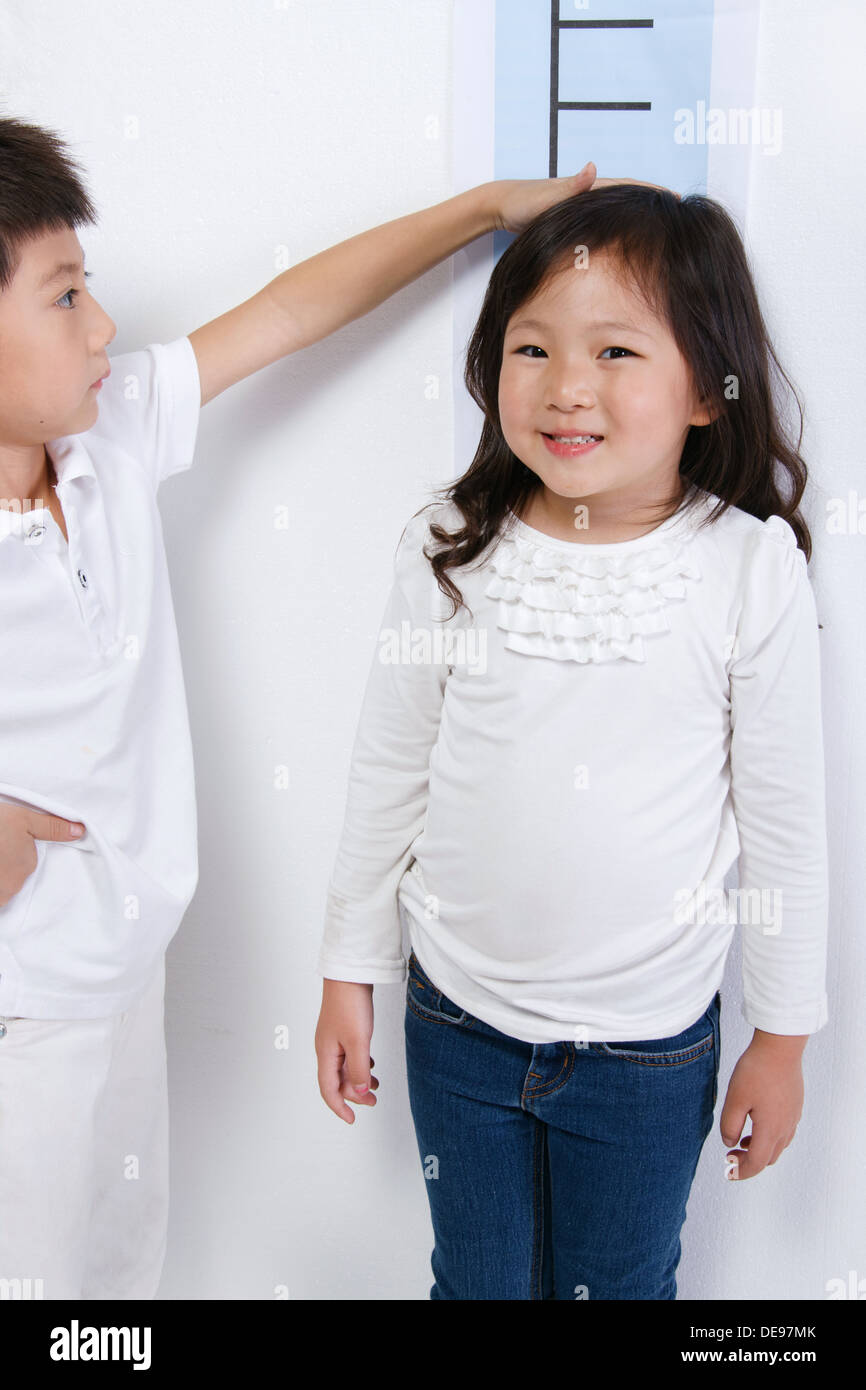 Girl measuring height Stock Photo - Alamy