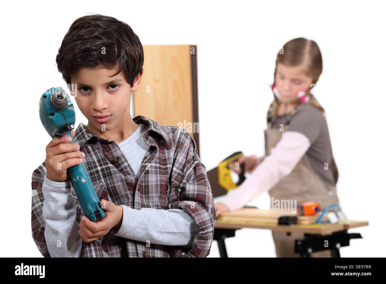 Two kids playing at being construction workers Stock Photo - Alamy
