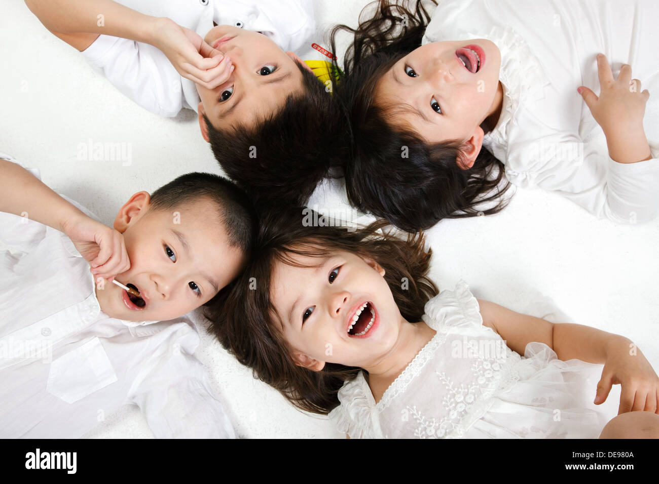 Children lying together Stock Photo - Alamy