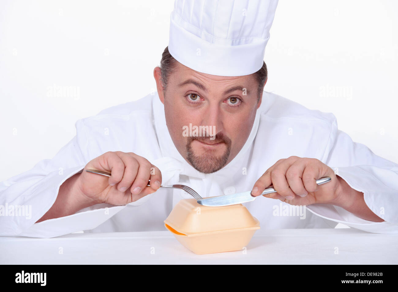 Chef eating a polystyrene foam takeaway box Stock Photo - Alamy
