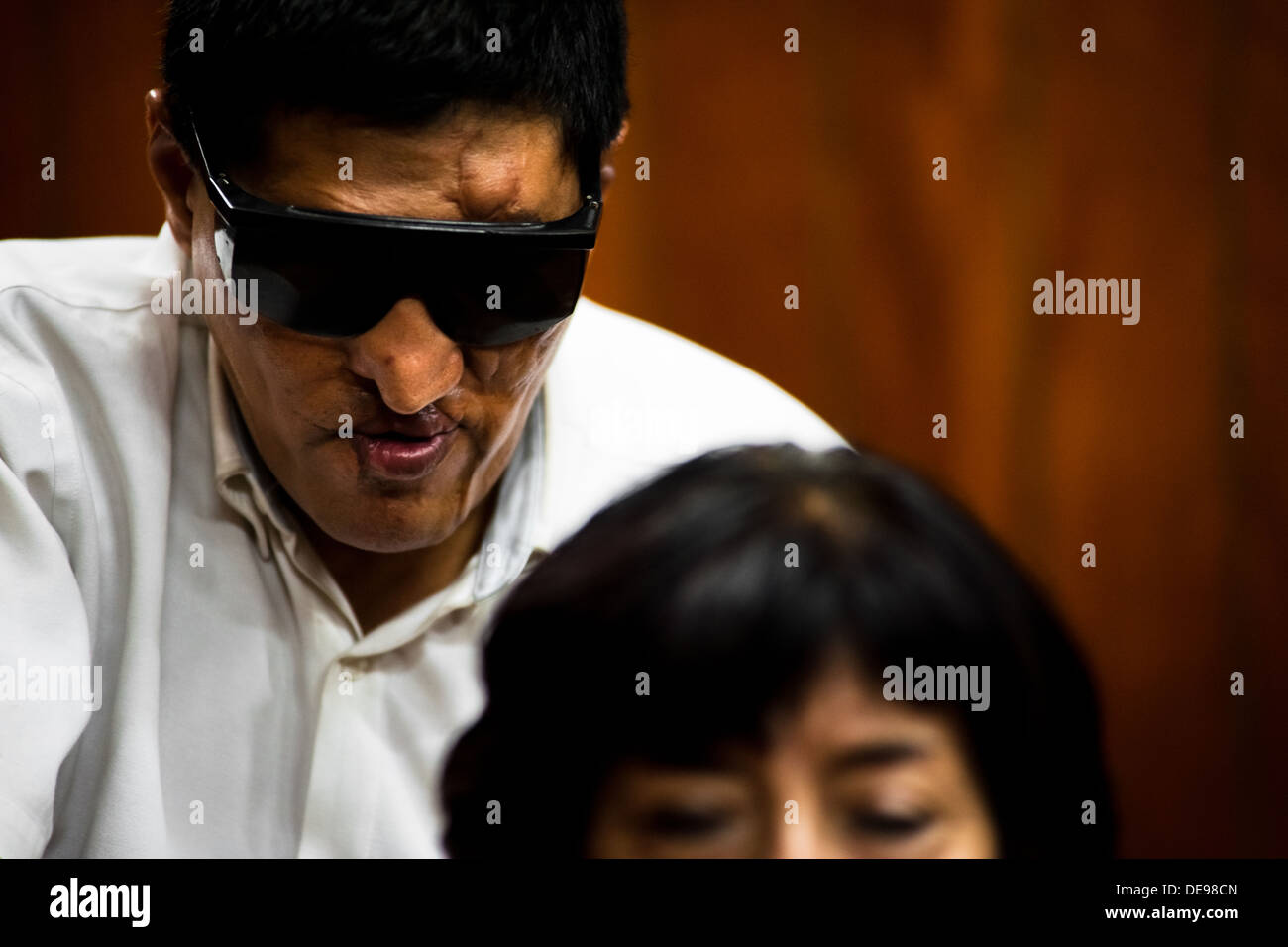 A blind man massages a client's back at the social club for the ...