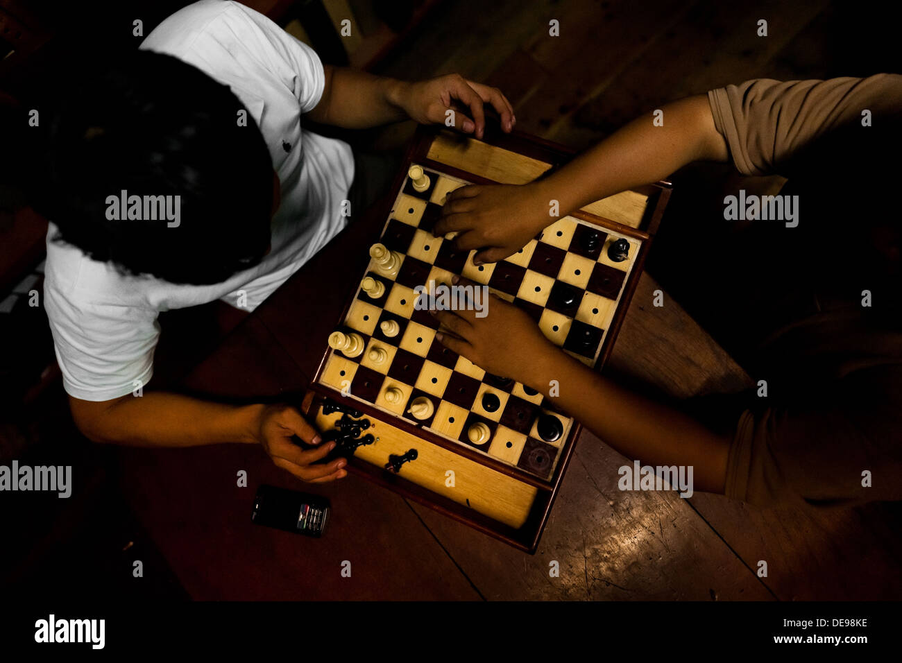 Blind men play chess in the library of Unión Nacional de Ciegos del ...