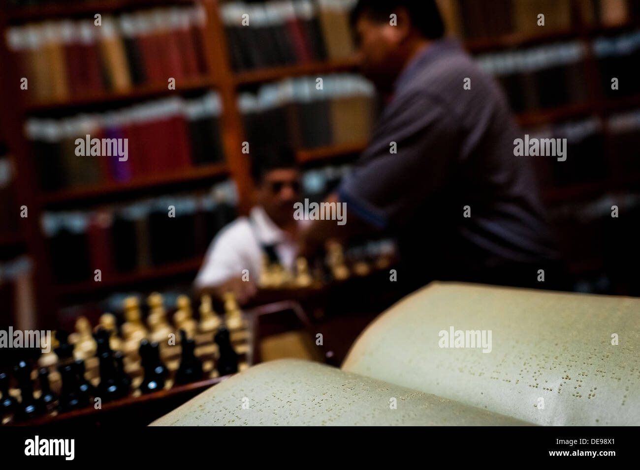 Blind men play chess in the library of Unión Nacional de Ciegos del ...
