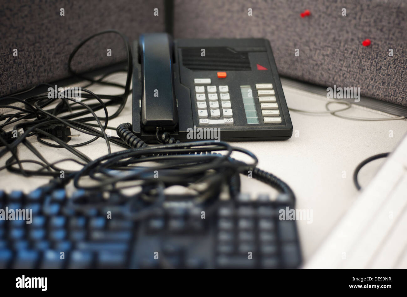 Dusty phone with tangled wires in an abandoned work space Stock Photo ...