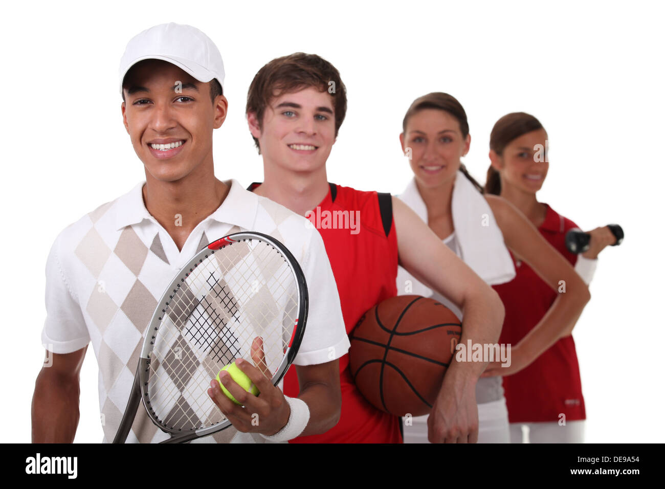 Four teenagers dressed for different sports Stock Photo - Alamy